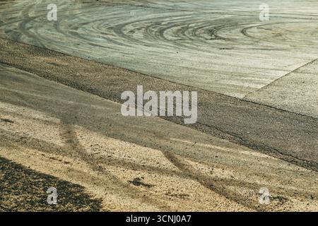 Black traces of car tires on the asphalt. Curved traces of burnt Stock ...