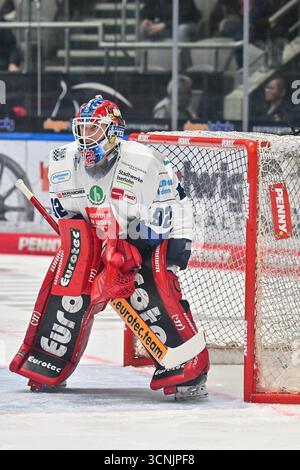 Andreas Jenike (Iserlohn Roosters #92) deflects the puck, Matthew ...