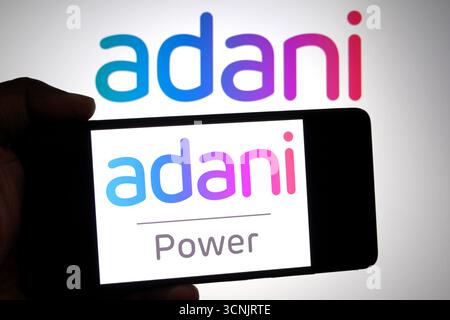 In this photo illustration, the Adani group logo is seen displayed on a ...