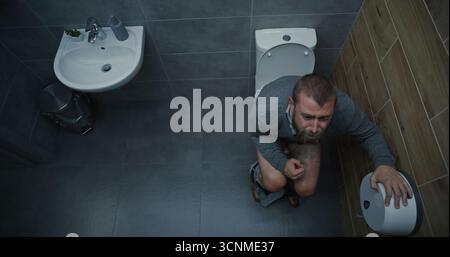 Man Entering in Restroom, Sitting on the Toilet and Suffering from ...