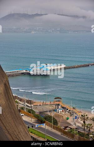 View of a building and cliffs along the Pacific Ocean at night in La ...
