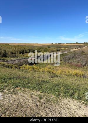 Railroad tracks on a vast landscape of the Canadian prairies leading ...