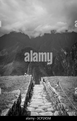 A stone steps trail in a mountainous area, with stone walls Stock Photo ...