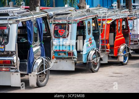 A line of Philippine traditional tricycles at a local town terminal in ...