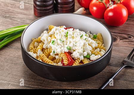 Italian pasta fusili with curd and dry tomato Stock Photo - Alamy