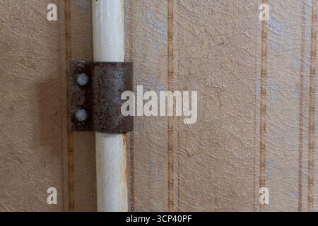The close-up view shows rusty metal with peeling layers and an uneven ...