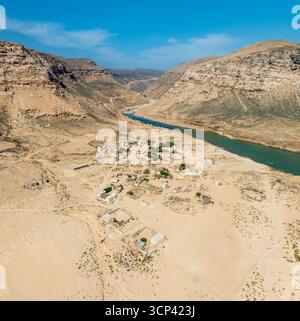 small turquoise river flowing into the sea at sunset and silk effect ...