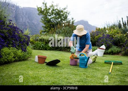 Senior gardener on light blue background with space for text Stock ...