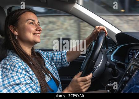 Woman behind steering wheel of modern car Stock Photo - Alamy