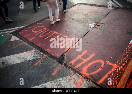 Pedestrians walk over a crosswalk on Miami Beach's iconic Ocean Drive ...