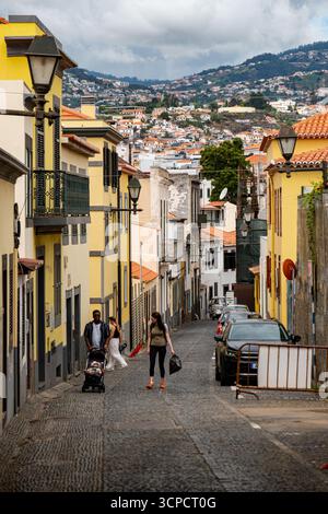 A woman pushes a baby stroller while walking around in a commercial ...
