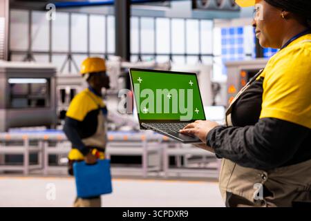 Female manager supervises production in a metal manufacturing plant ...