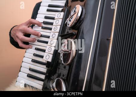 Musician playing a folk instrument, pressing keys on an accordion Stock ...