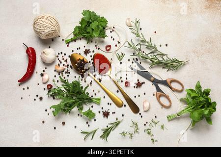 Composition with herbs, threads, scissors and spoons of spices on white ...