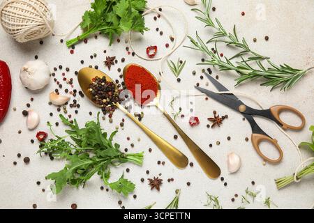 Composition with herbs, threads, scissors and spoons of spices on white ...
