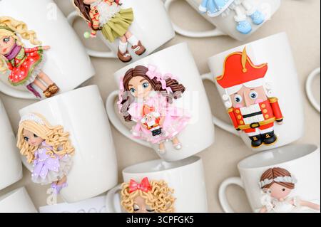 A Christmas doll figurine, a festive mug, a French press of tea and a ...