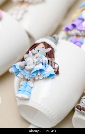 A Christmas doll figurine, a festive mug, a French press of tea and a ...