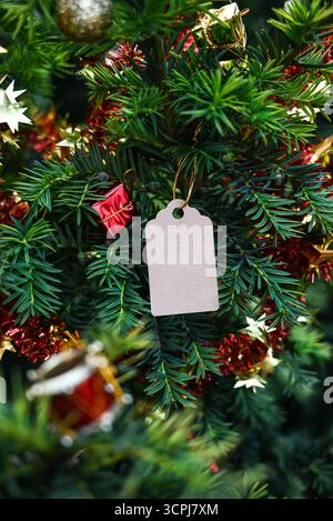 Kraft christmas gift with a blank tag mockup on a red background Stock ...