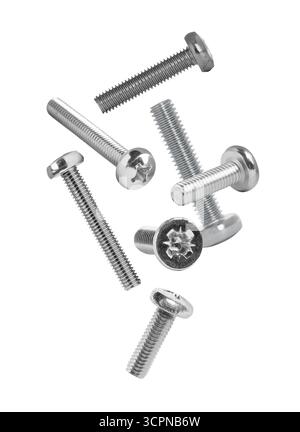 Different metal bolts falling against white background Stock Photo - Alamy