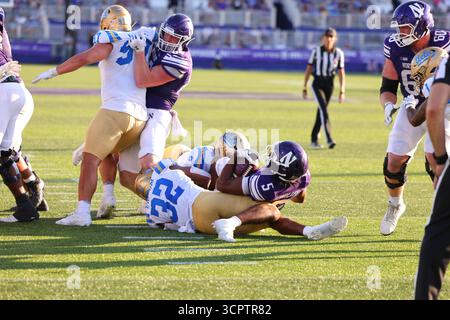 Northwestern running back Caleb Komolafe, left, catches a pass as ...