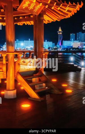 Traditional lakeside pavilion glowing at night with modern Sokcho ...