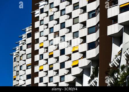 Yellow Residential Facade with Repeating Windows and Balconies in ...