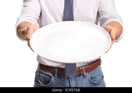 Male hands holding empty plate on dark background, lack of food, hunger ...