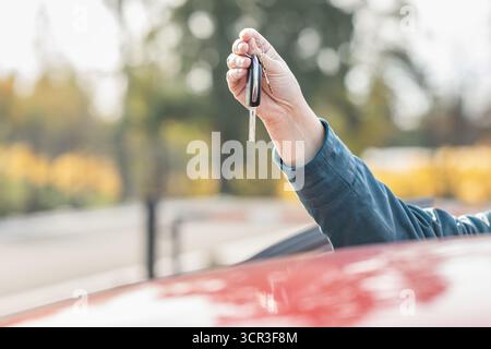 Female hand holding a car key isolated on white background Stock Photo ...