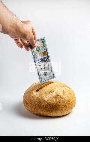 loaf of bread on a man's hand isolated on gray background close up ...