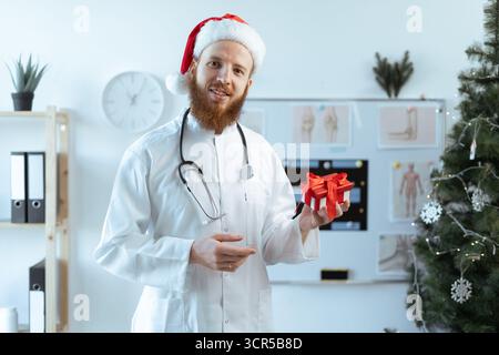 Doctor with gift box in the hospital Stock Photo - Alamy