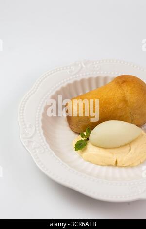 Elegant serving of Neapolitan rum baba dessert with creamy custard and ...