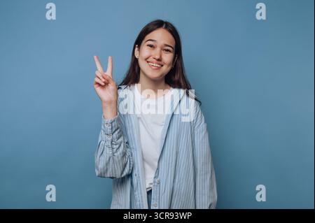Young Woman Expresses Joy and Positivity With Thumbs up in a Pink ...
