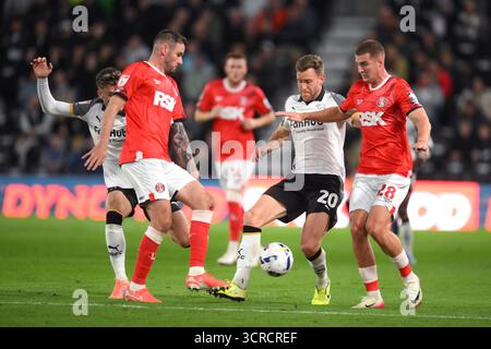 Derby County's Callum Elder (centre) battles for the ball during the ...