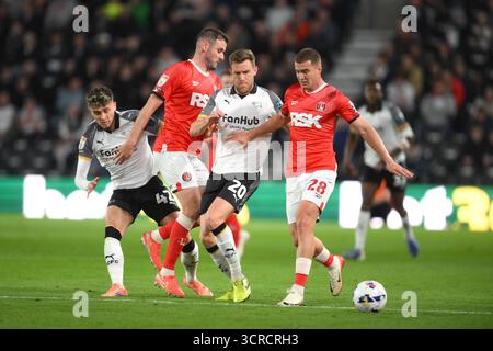 Derby County's Callum Elder (centre) battles for the ball during the ...