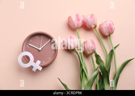Menopause. Female gender symbol and alarm clock on light grey ...