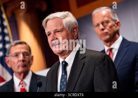 Sen. John Hoeven (R-N.D.) speaks with reporters as he departs a Senate ...