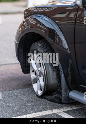 Closeup of a badly damaged car tire on the ground at daytime Stock ...