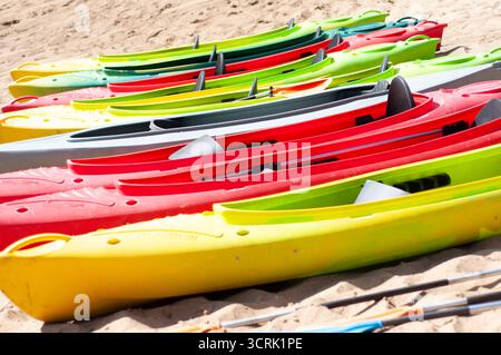 multi-colored canoes on the sand Stock Photo - Alamy
