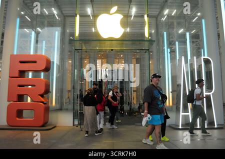 People exit an Apple store on Fifth Avenue in Manhattan, New York City ...