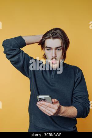 Young Man Displays Modern Smartphone Screen for App Advertisement in ...