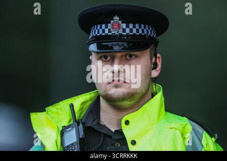 Police wait on standby as the sun has set and it begins to get dark ...