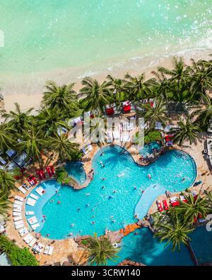 Aerial view of the vibrant beach teeming with sunbathers and swimmers ...