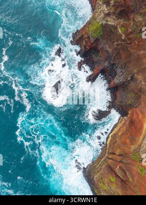 Reddish water of a sea against the blue sky. Guaibim sandy beach ...