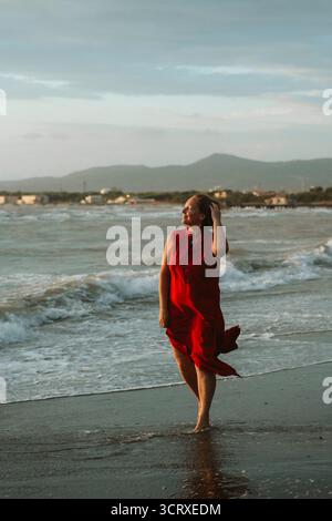 Woman in mountains with flowing dress and wind. Woman outdoor lifestyle ...