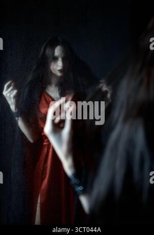 Horror scene: blurry reflection of the ghost girl in old dirty mirror ...