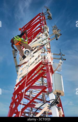 technician working at signal tower Stock Photo - Alamy