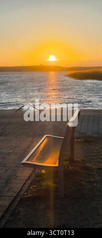 Empty bench on a pier during winter, waiting for more inviting weather ...