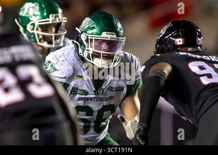 Saskatchewan Roughriders Jacob Brammer (66), Samuel Emilus (19) and ...