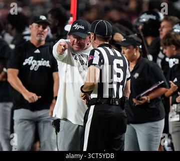 Mississippi State head coach Mike Leach talks to an official during the ...