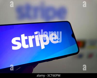In this photo illustration a Stripe logo seen displayed on a smartphone ...
